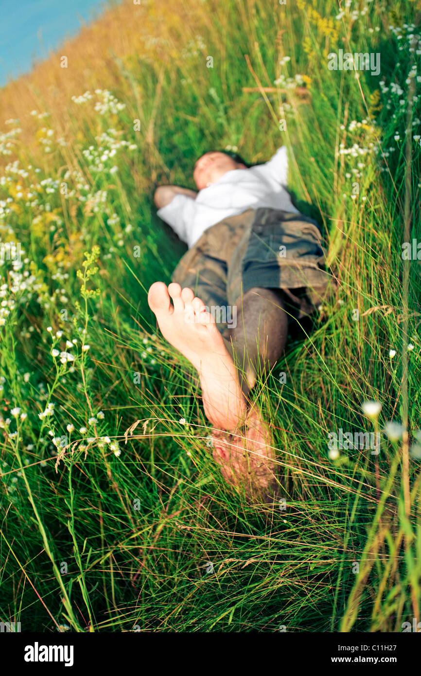 young adult man in spring grass Stock Photo - Alamy