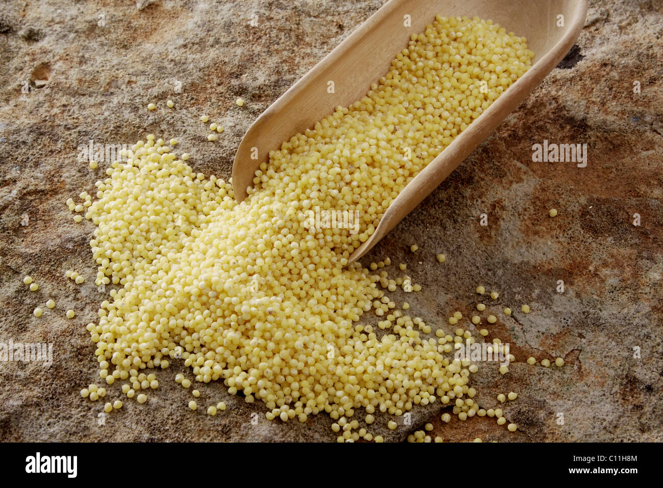 Millet (Panicum miliaceum) with a wooden shovel, on stone surface Stock ...