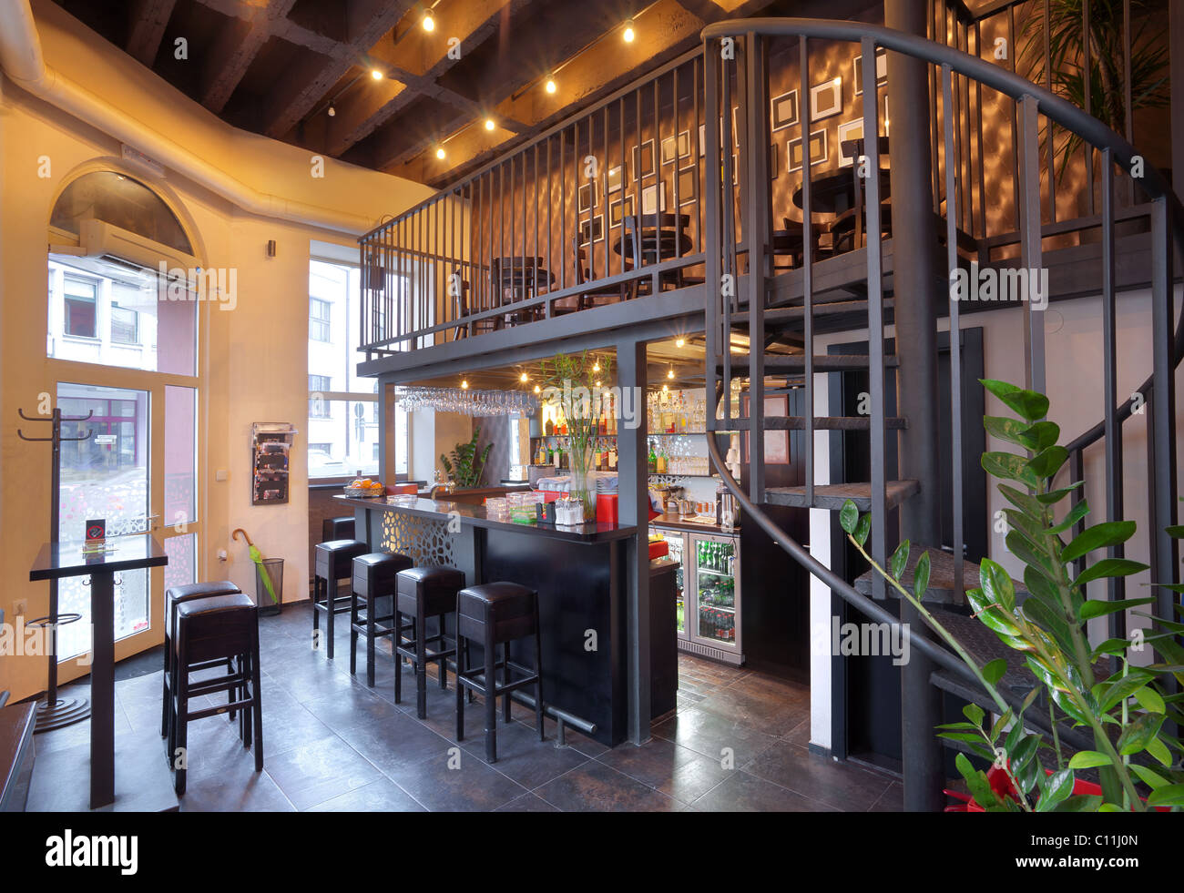 Interior of a pub with furniture during day Stock Photo - Alamy