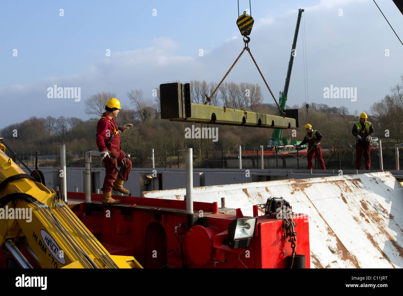 Crane unloading the sea-going barge Terra Marique on the River Ribble ...