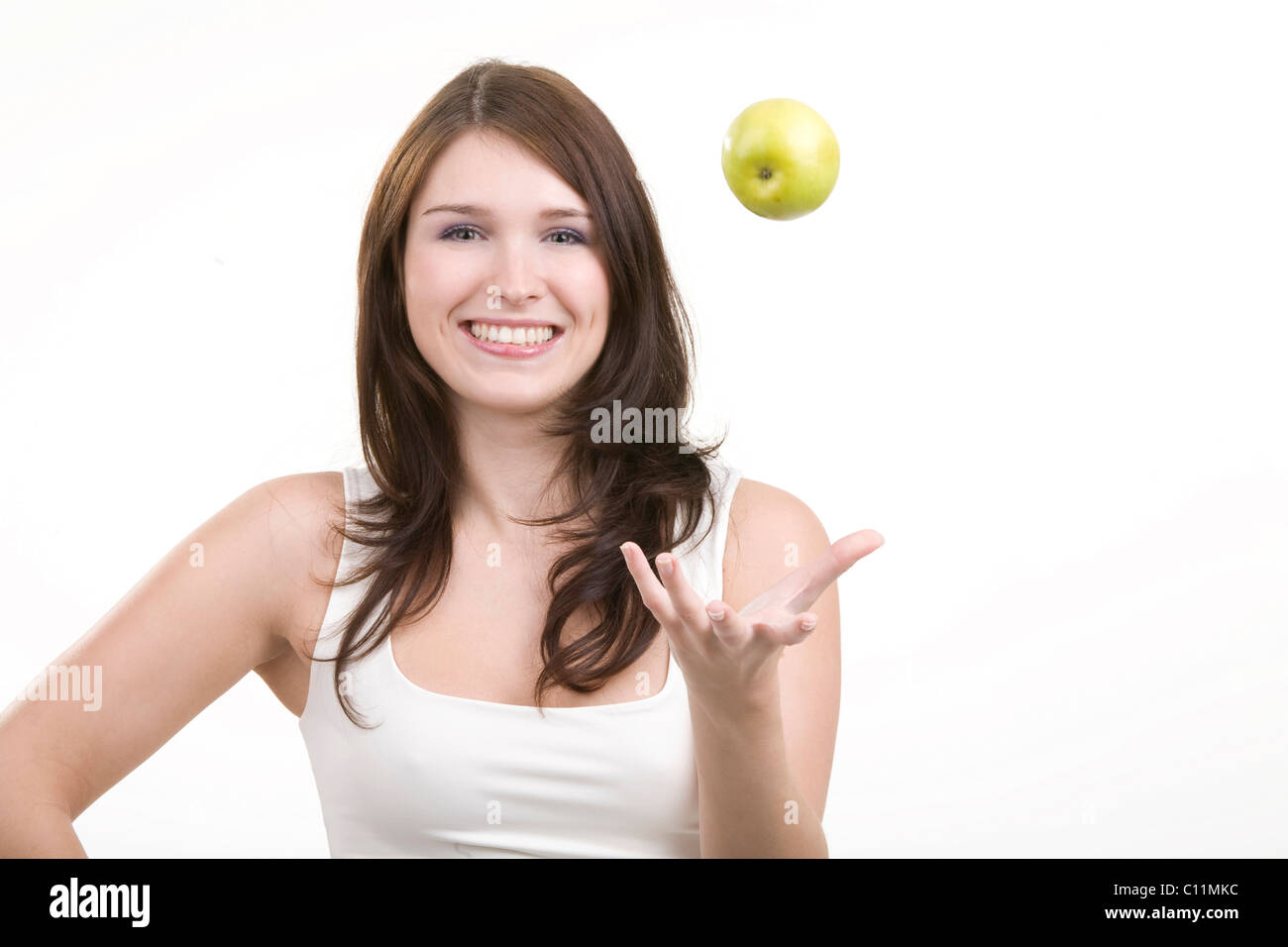 Woman throwing an apple Stock Photo - Alamy