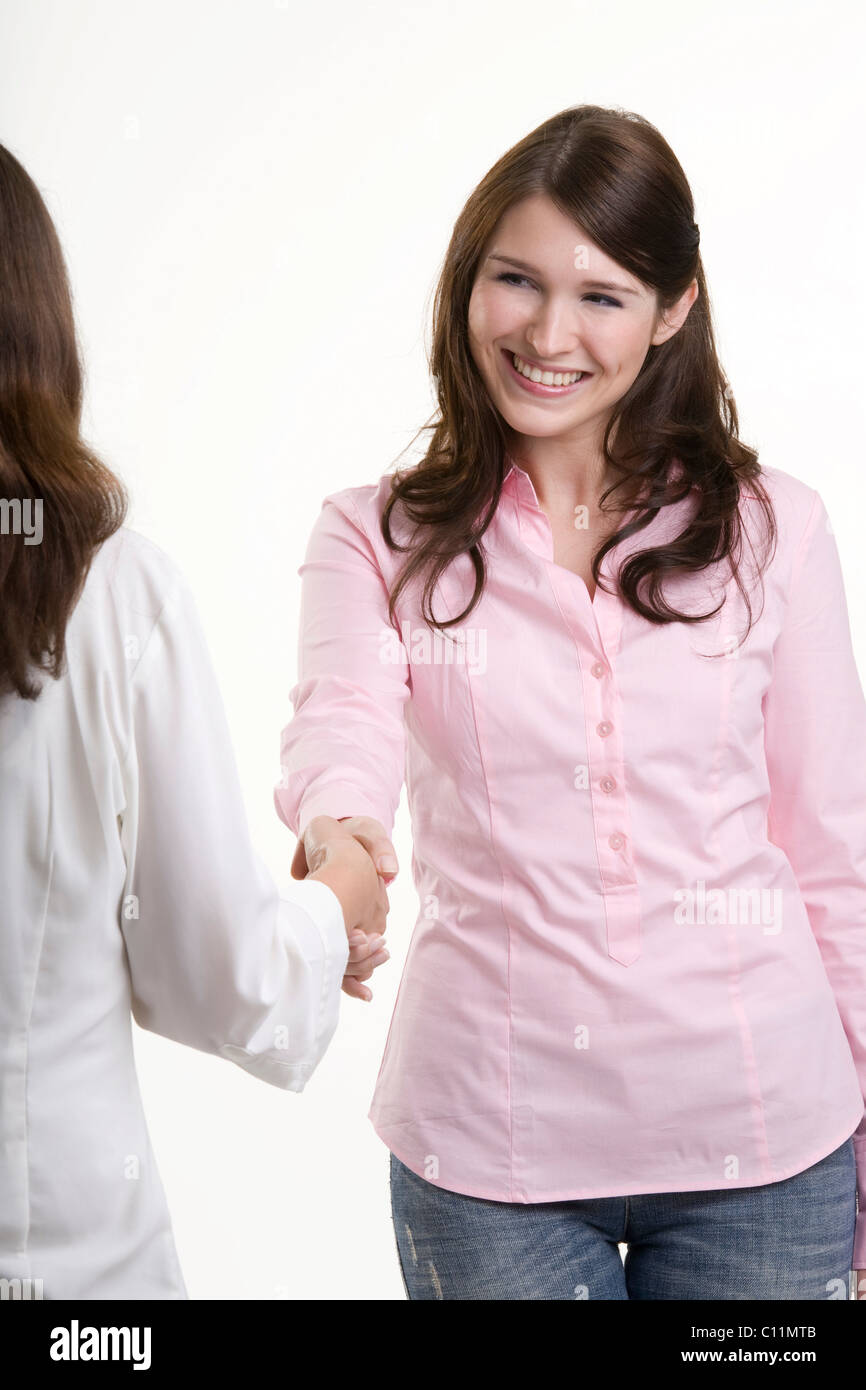 Two women shaking hands Stock Photo - Alamy