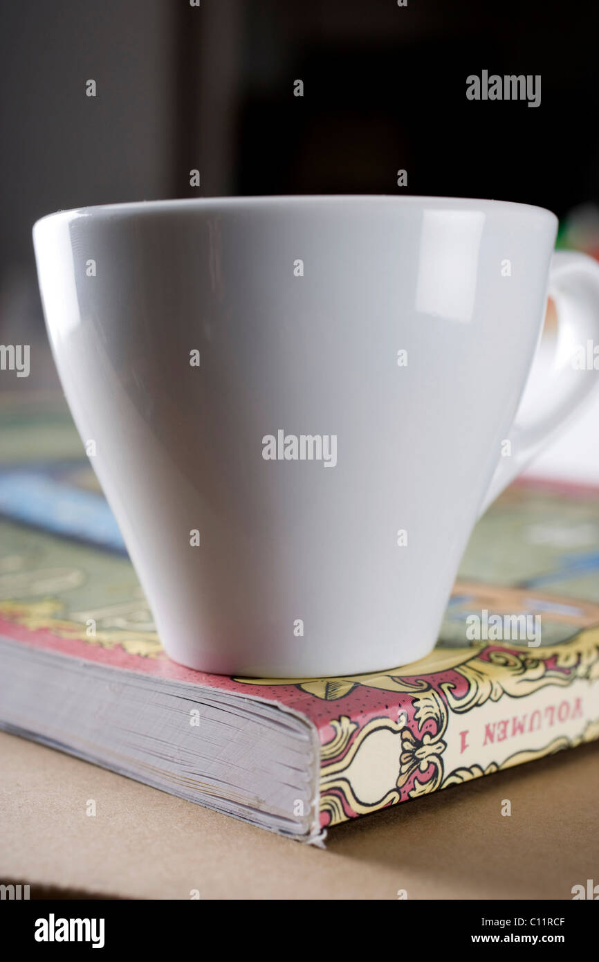 Coffee cup and book Stock Photo - Alamy