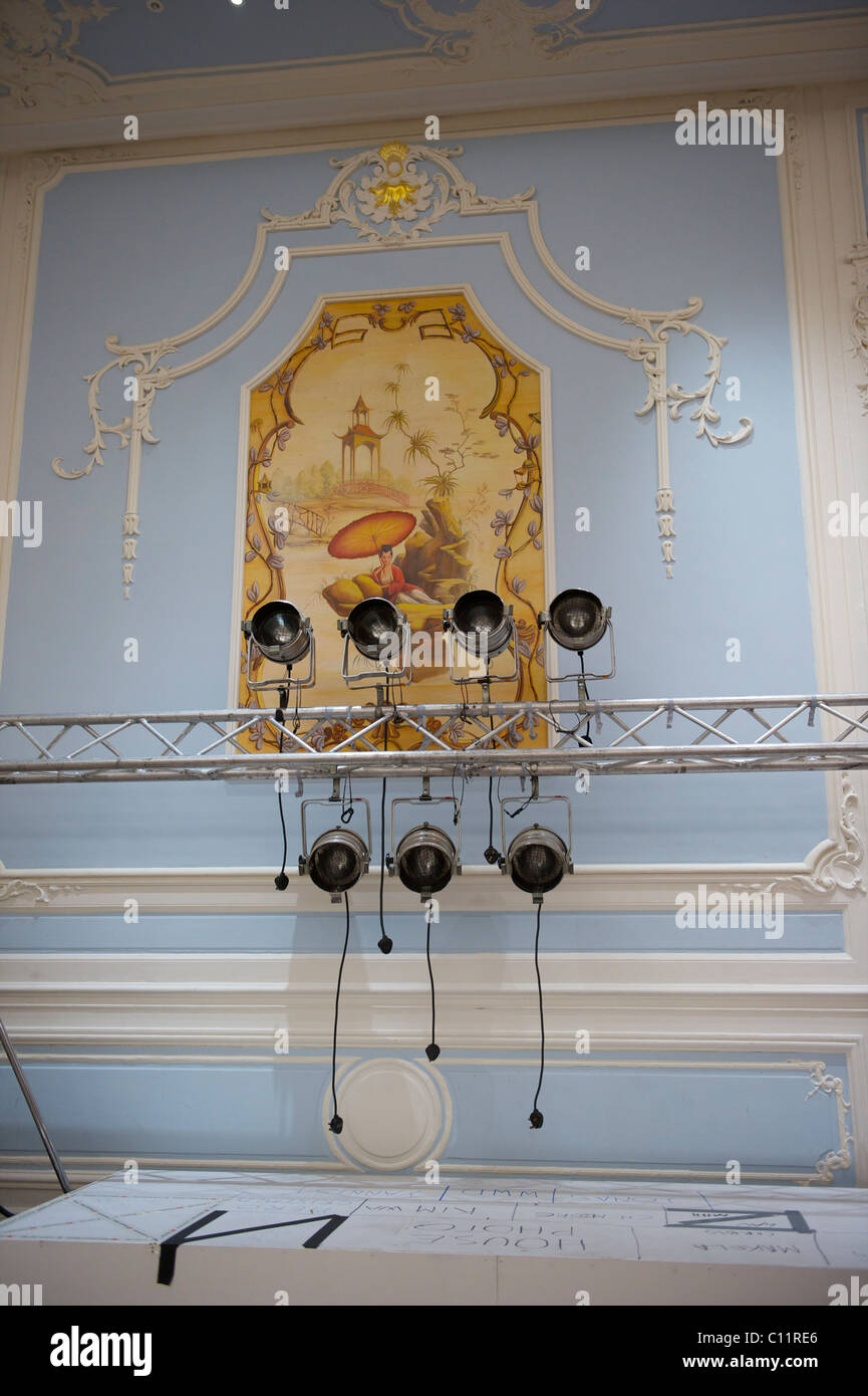 Wokers dissemble the catwalk lights following the Maria Grachvogel ...