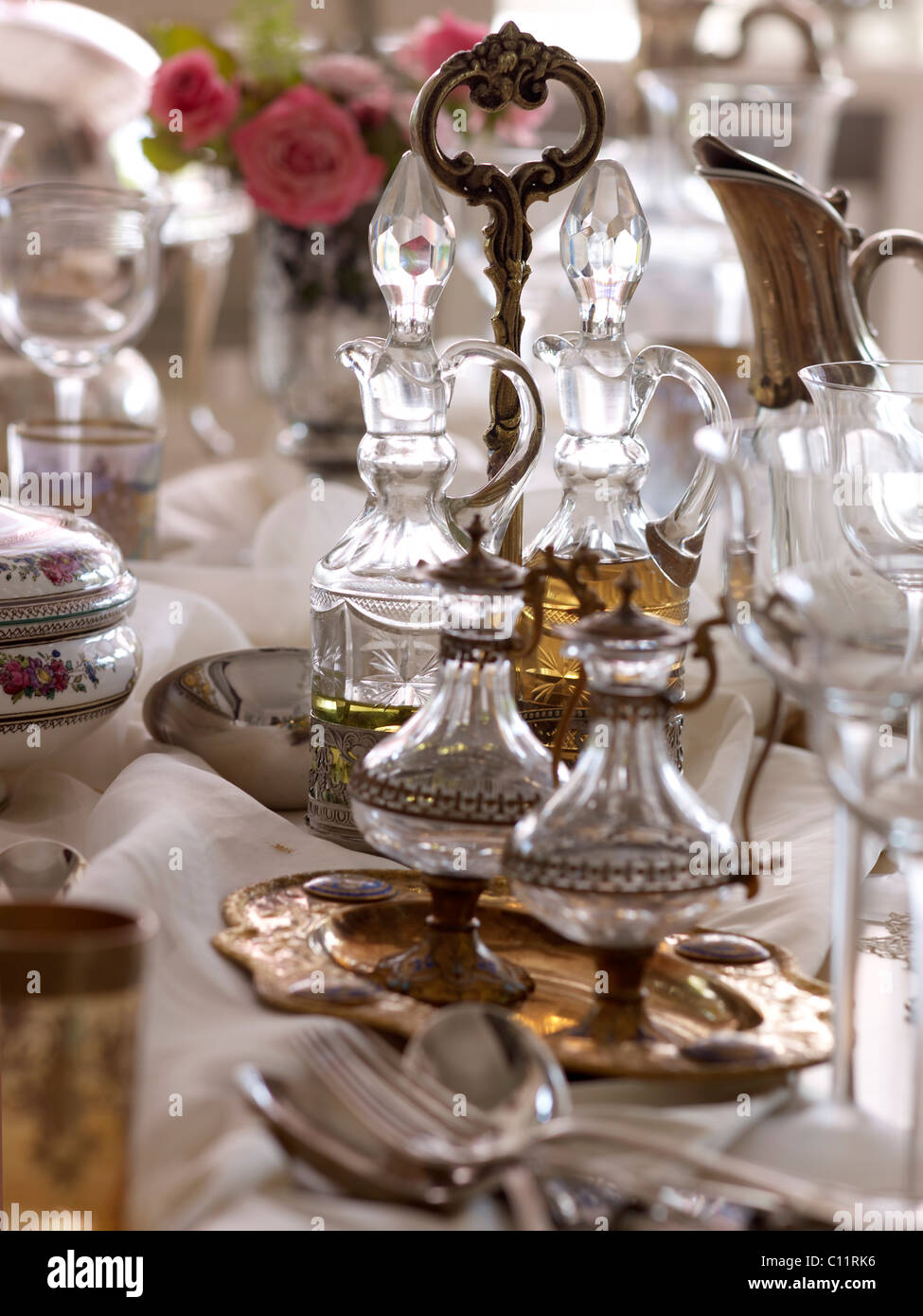 Exclusive, elegant glass carafes on a beautifully-laid table, in a ...