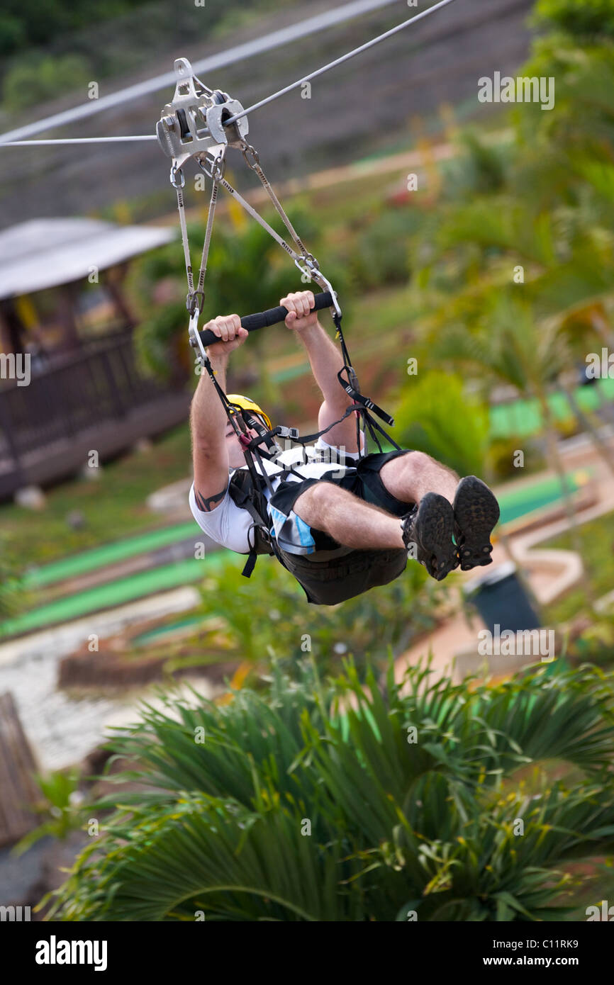 Man on a zipline Stock Photo - Alamy