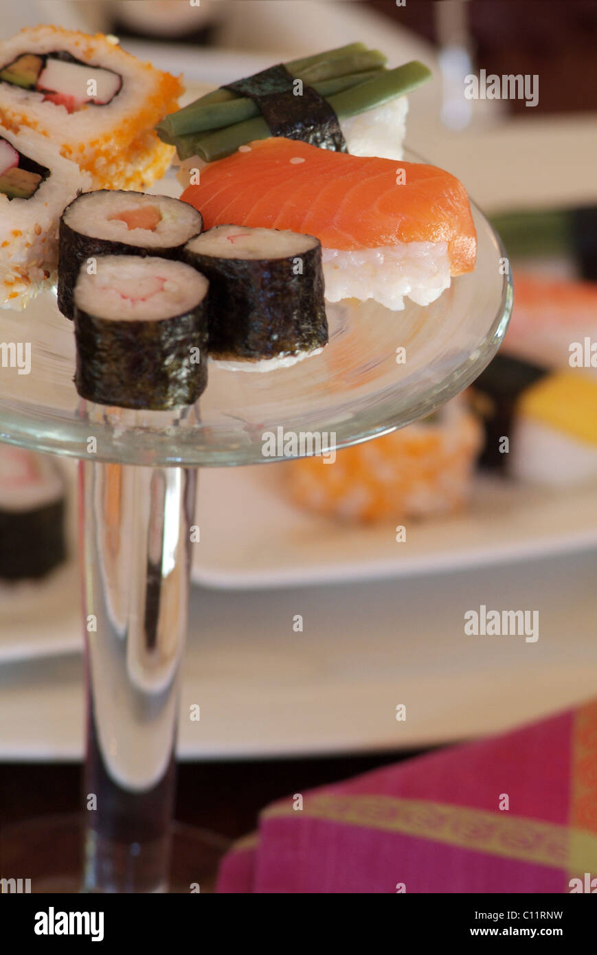 Sushi on a glass dish served on an elegantly set table Stock Photo - Alamy