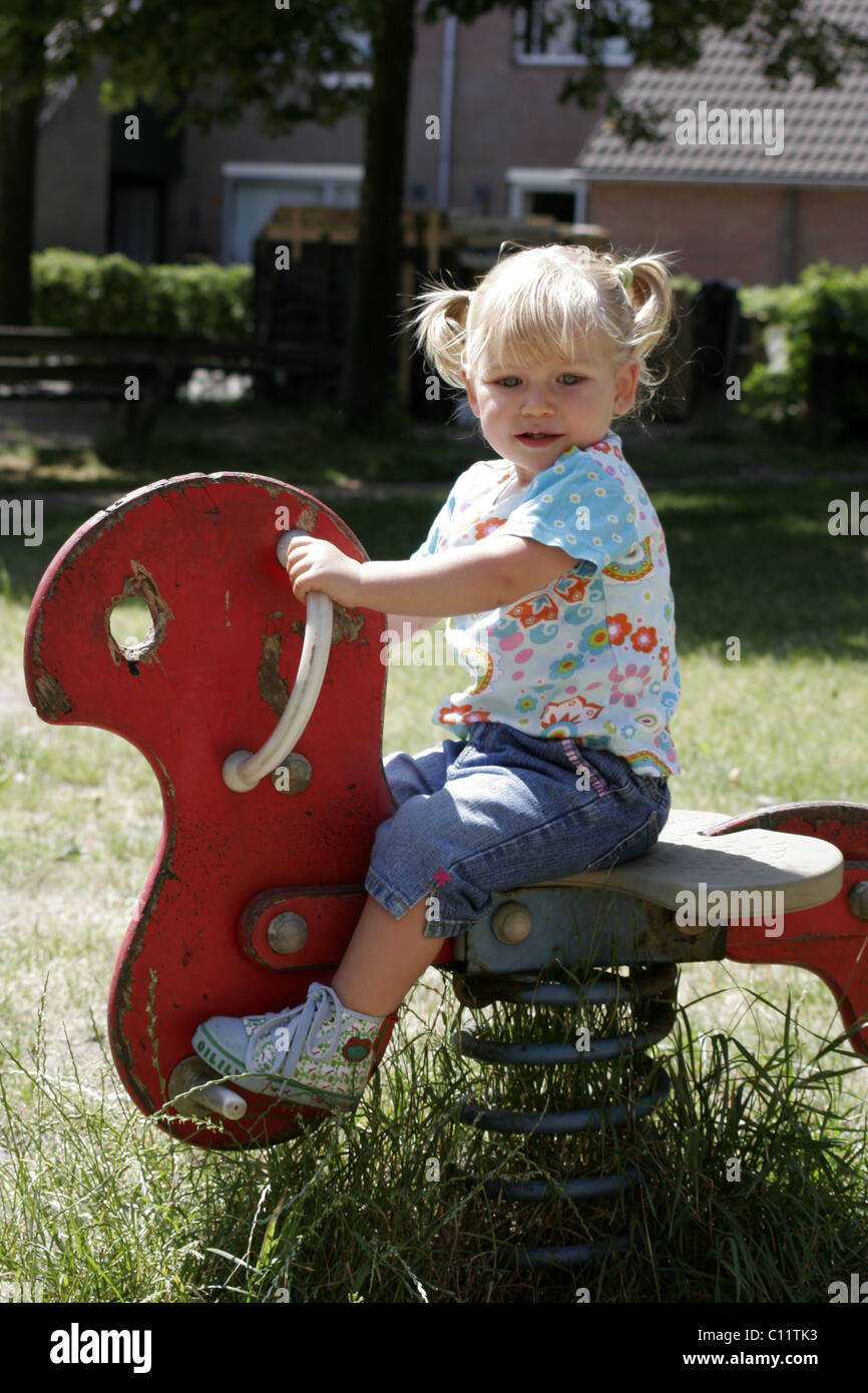 Children playing happily playground hi-res stock photography and images ...