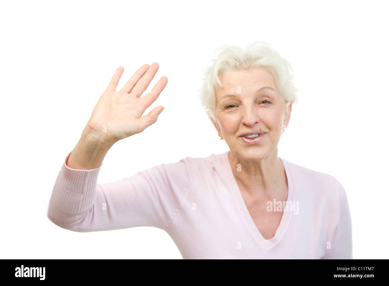 Old woman waving Stock Photo - Alamy