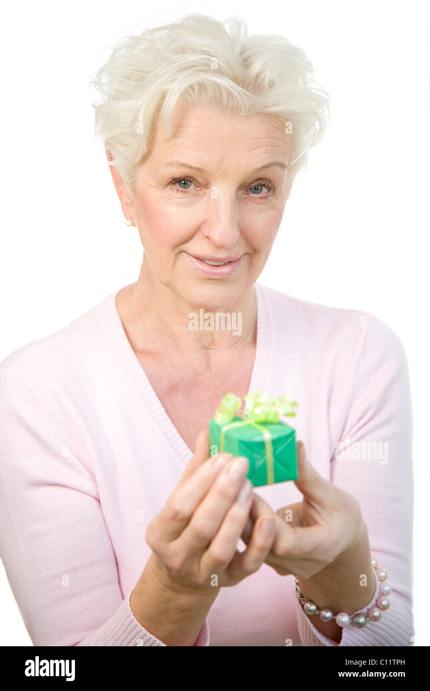 Old woman holding present Stock Photo - Alamy