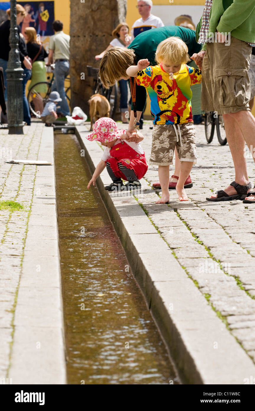Children and Freiburger Baechle brook, Freiburg, Baden-Wuerttemberg ...