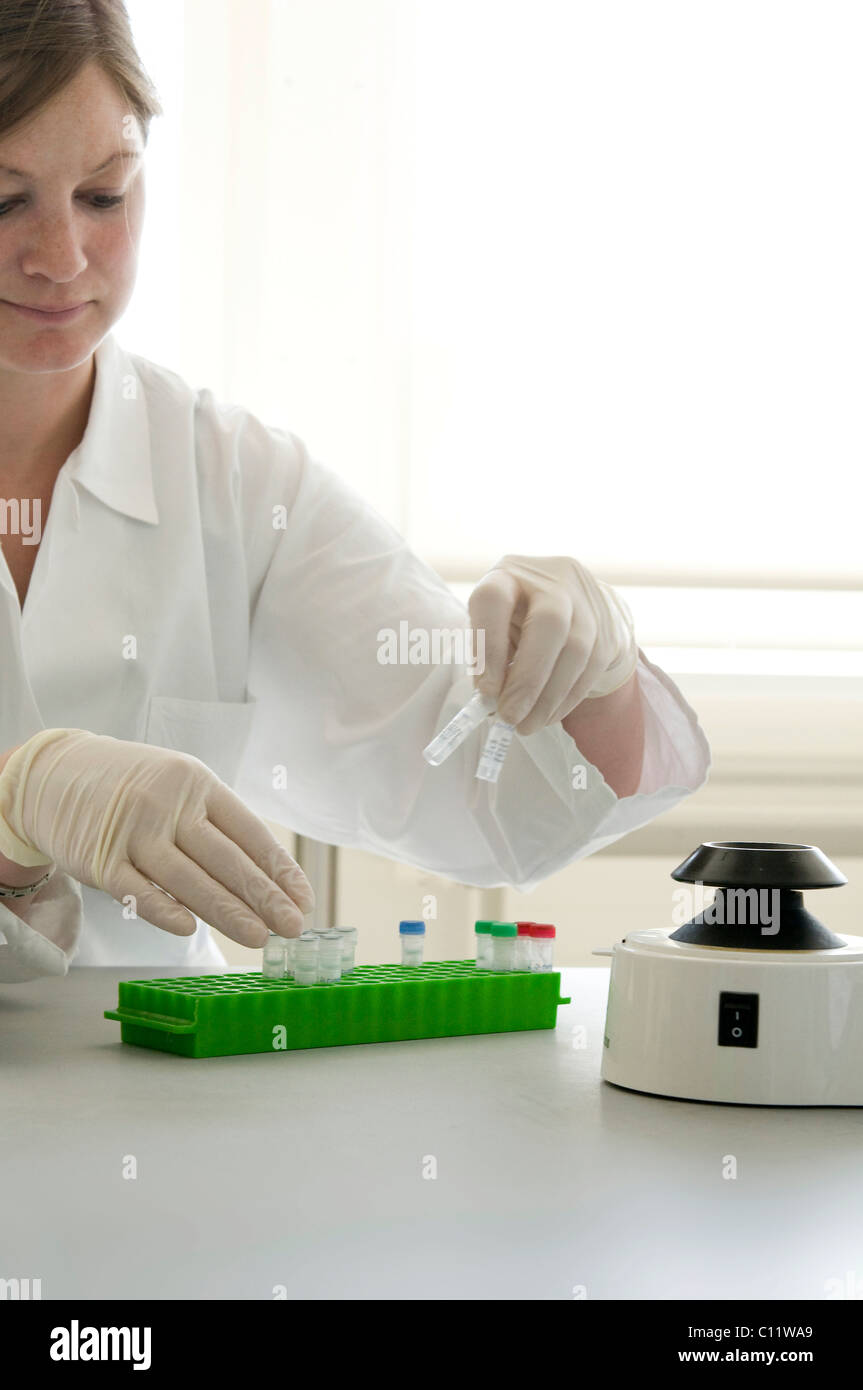 Laboratory employee with centrifuge Stock Photo - Alamy