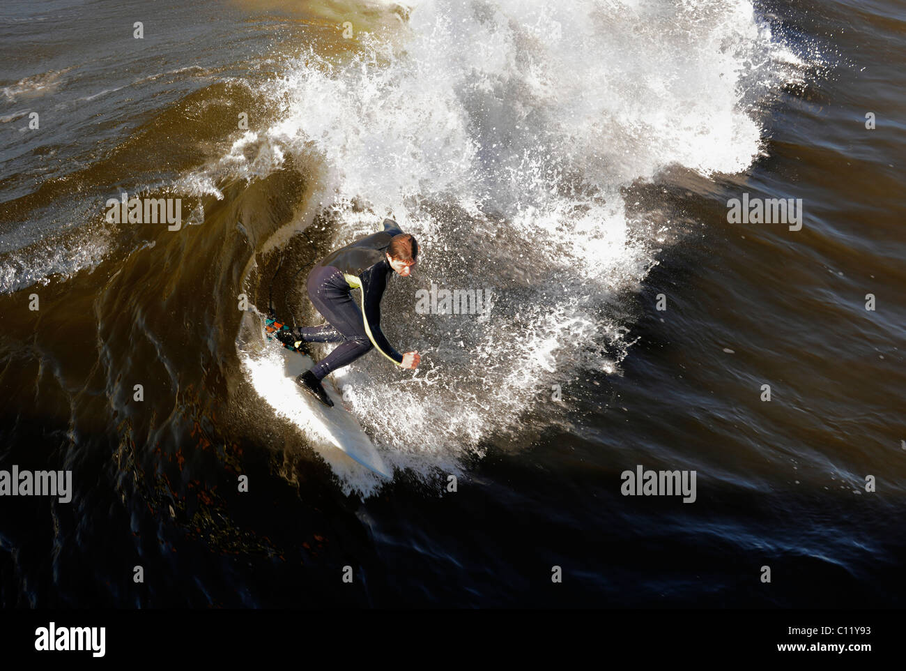 Surfer gets up on a wave. The wave twists with foam and splashes Stock ...