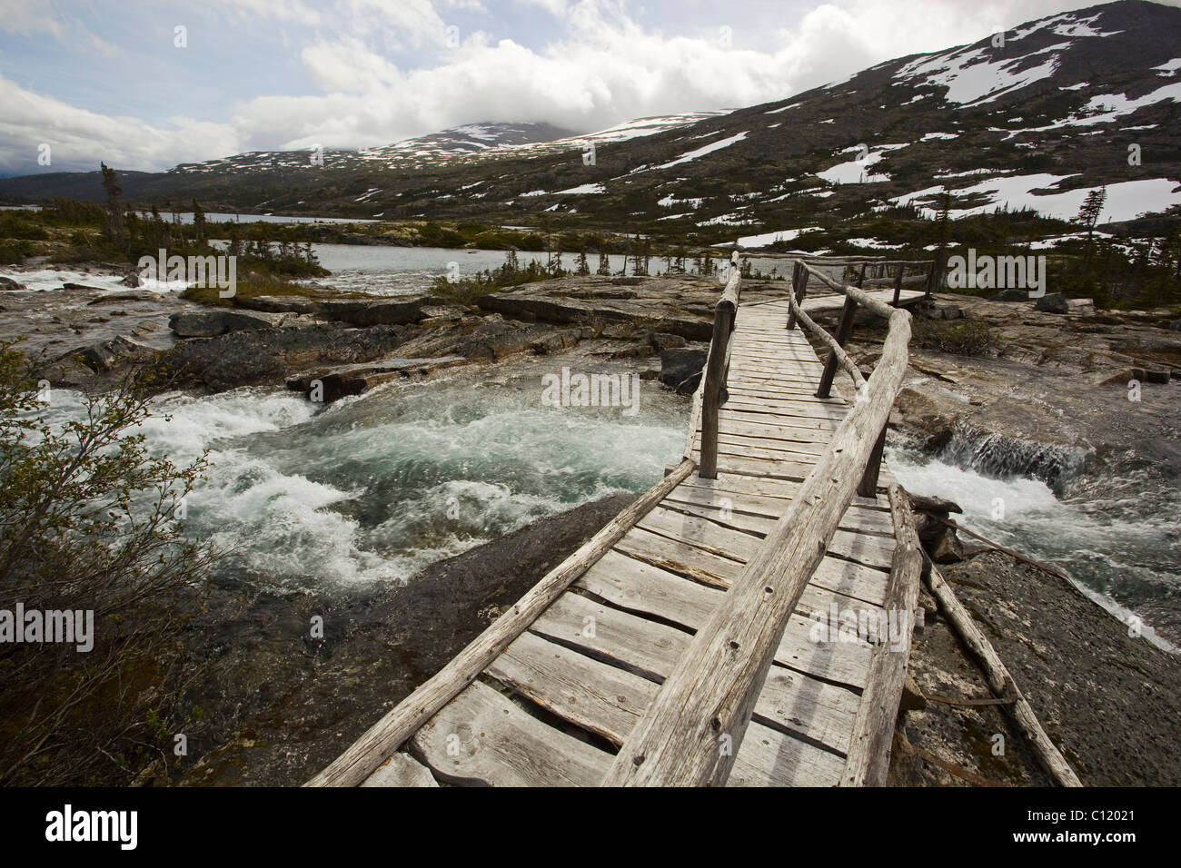 Crooked wooden foot bridge crossing creek, alpine landscape, Deep Lake ...