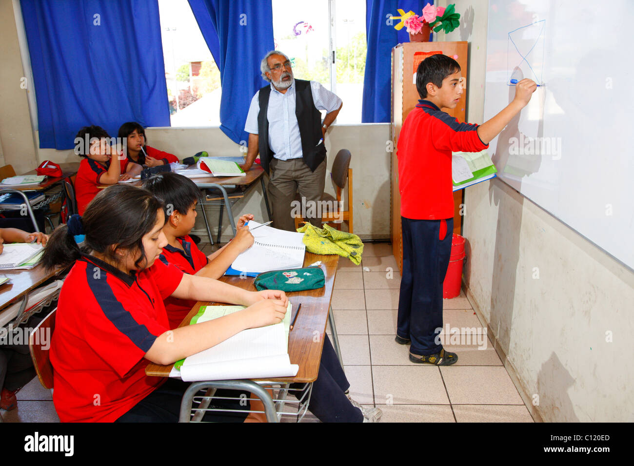 Schoolboy at the blackboard during class, Belem school, Santiago de ...