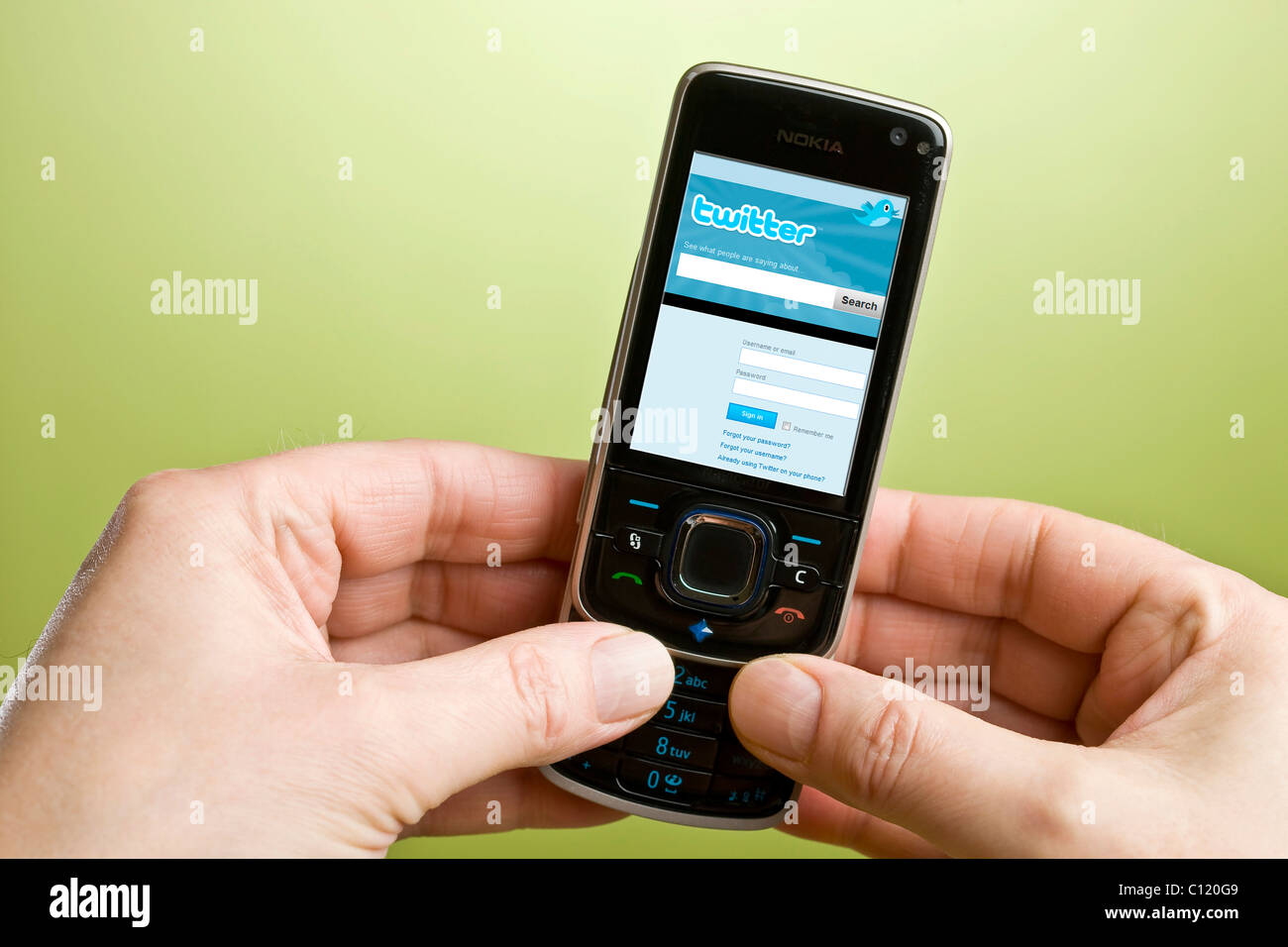 Using Twitter on a mobile phone Stock Photo - Alamy