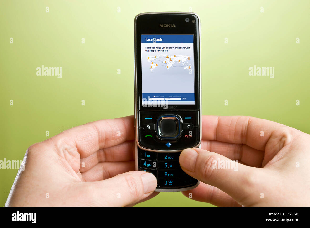 Using Facebook on a mobile phone Stock Photo - Alamy