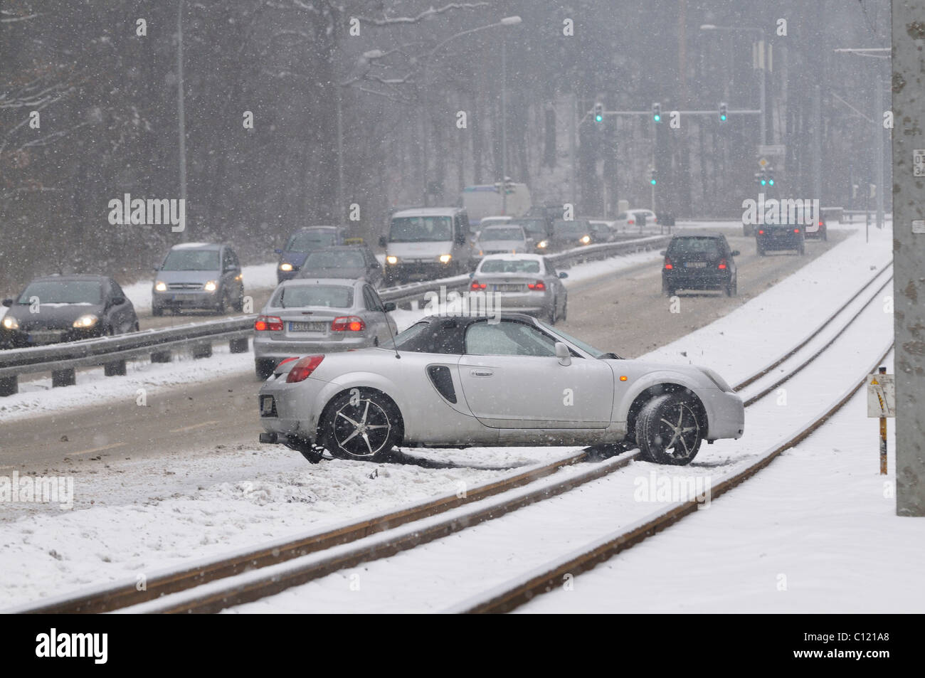 Snow in Stuttgart, a car having skid onto the S-Bahn tram tracks ...
