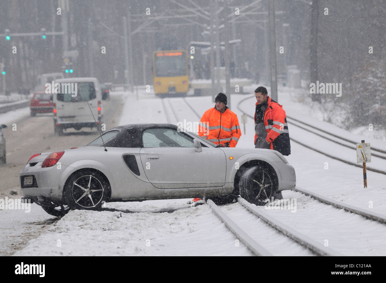 Snow in Stuttgart, a car having skid onto the S-Bahn tram tracks ...