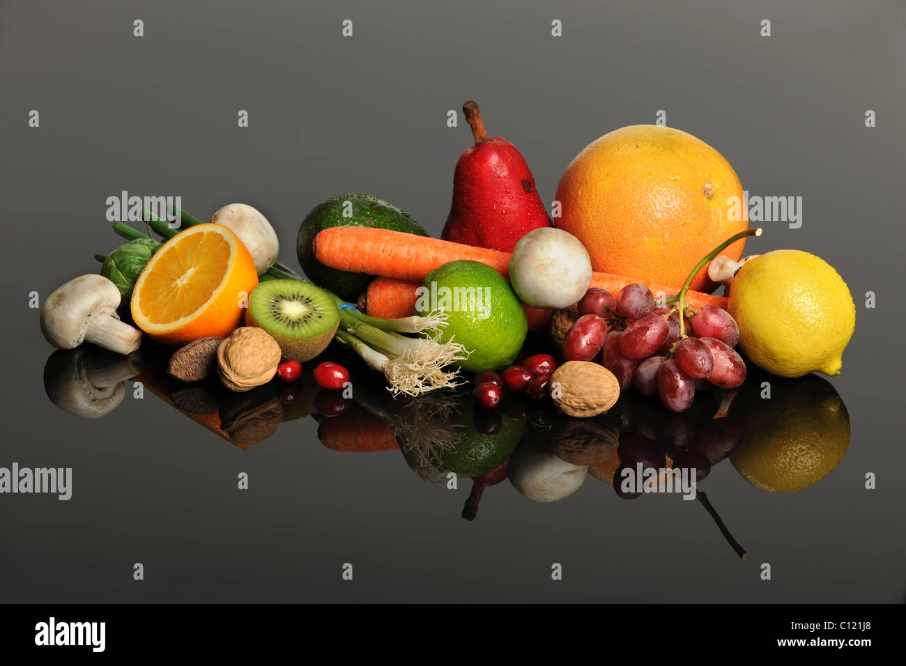 Fresh fruits and vegetables over reflective table Stock Photo - Alamy
