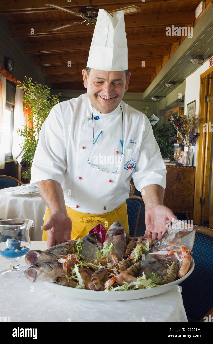 Cook with seafood platter at the beach restaurant Foresta, Marina di ...
