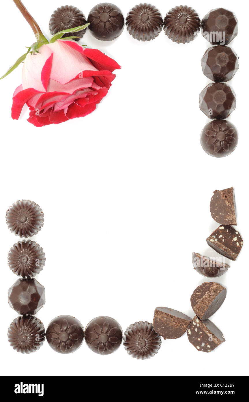 Beautiful red rose and chocolate frame on white background Stock Photo ...