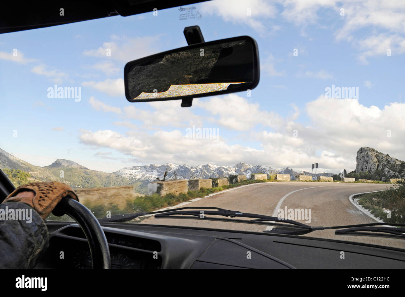 View from a car window while driving towards a curve on a mountain road ...