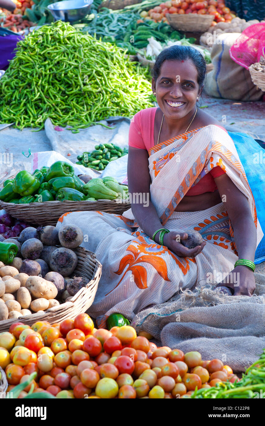 Happy Indian woman trading at a street vegetable market in Puttaparthi ...