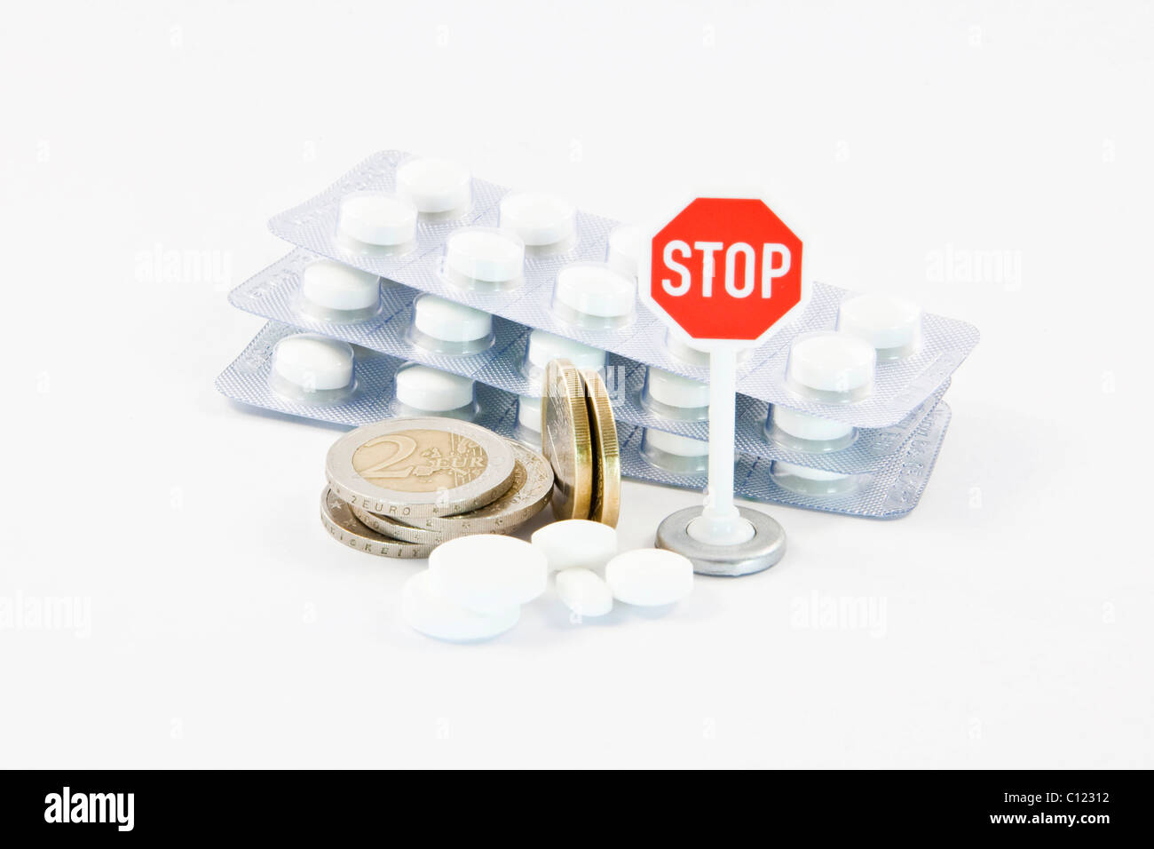 Money, stop sign, pills and medication, symbolic picture for medical ...