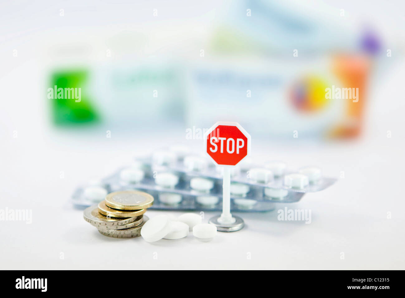 Money, stop sign, pills and medication, symbolic picture for medical ...
