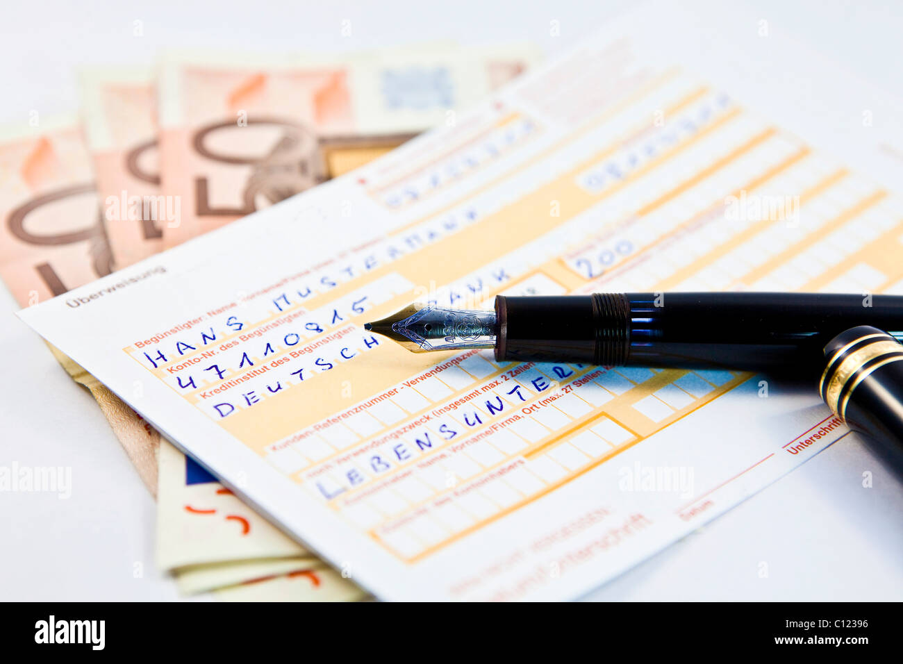 Bank transfer form on a pile of 50 euro banknotes Stock Photo - Alamy