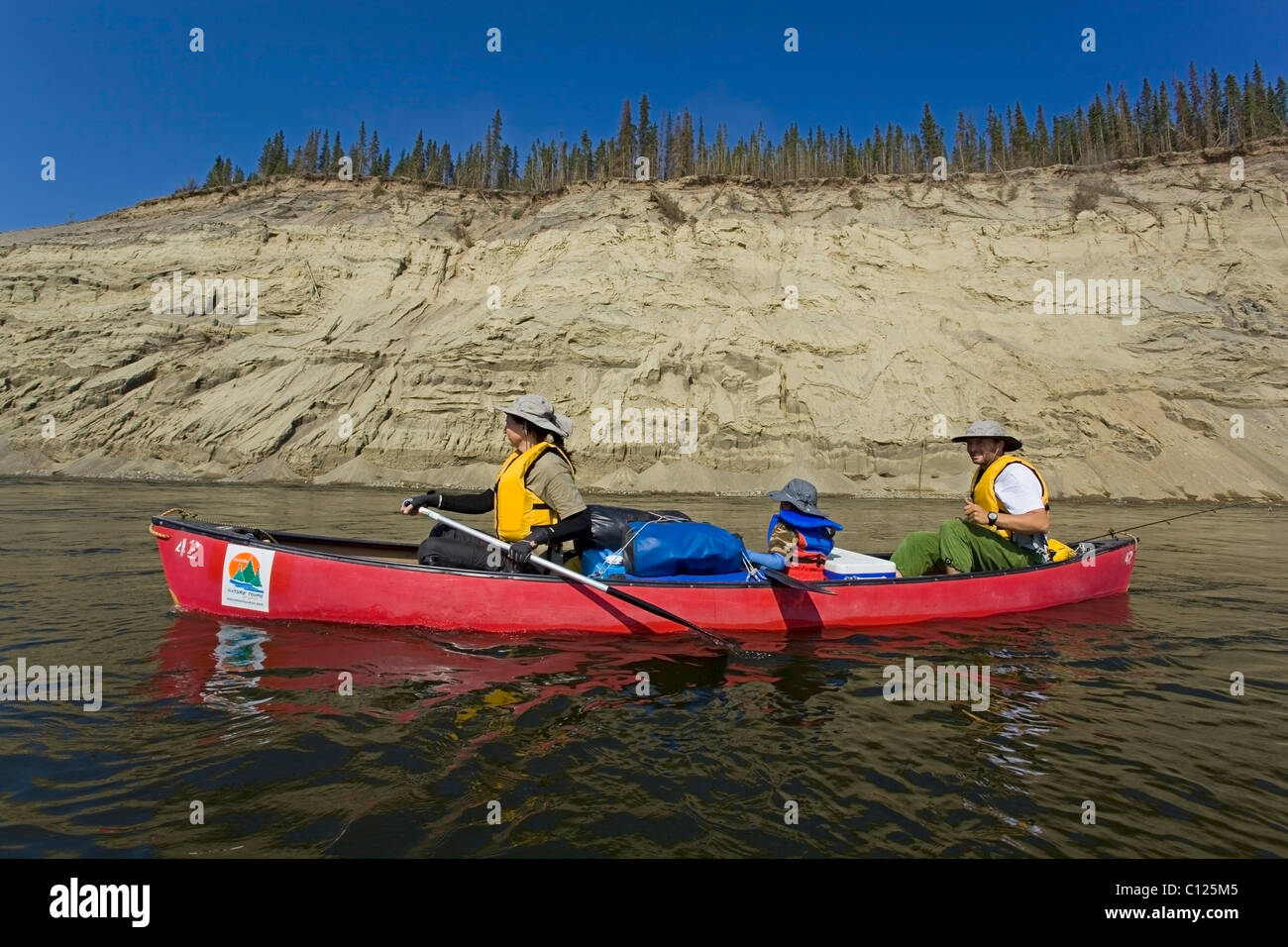 Family with young boy in a canoe, paddling, canoeing on Teslin River ...