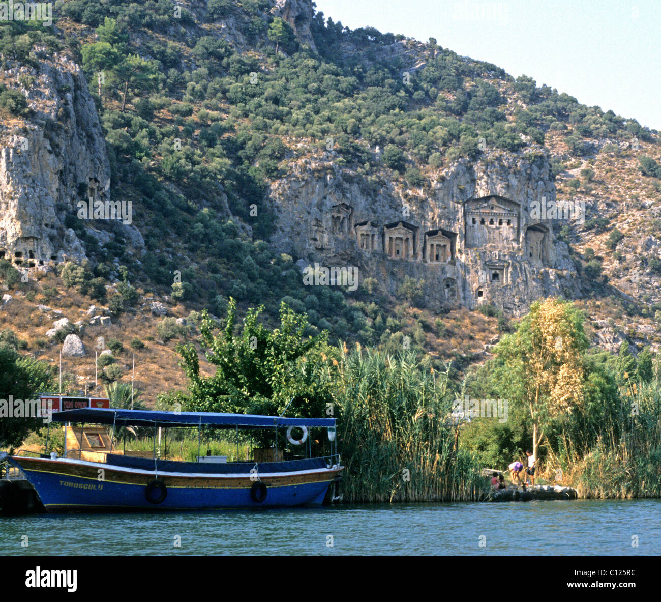 The Lycian rock tombs in the cliffs above the ruins of Kaunos, Kaunus ...