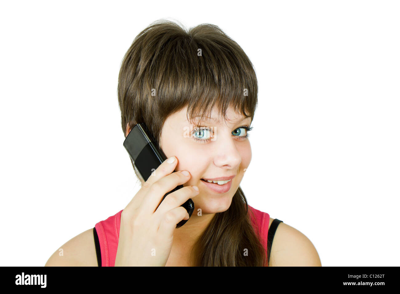 smiling beautiful girl with a phone on an isolated white background ...