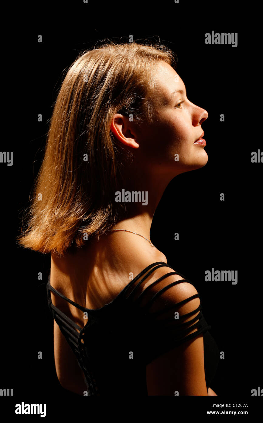 Young woman in a strapless top, profile, back view Stock Photo - Alamy