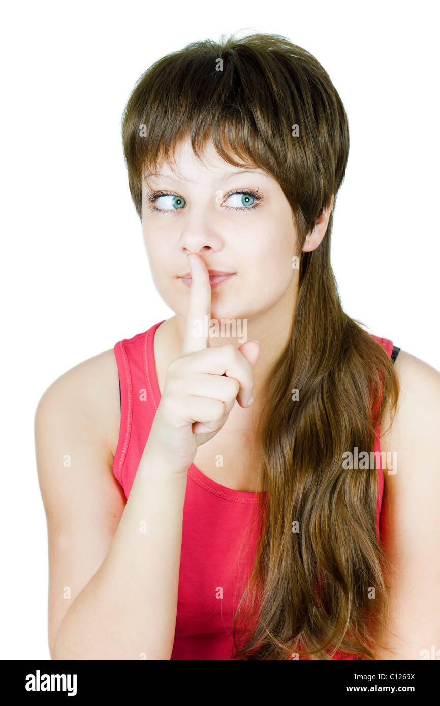 portrait of a beautiful blue-eyed girl clamping finger to lips on an ...