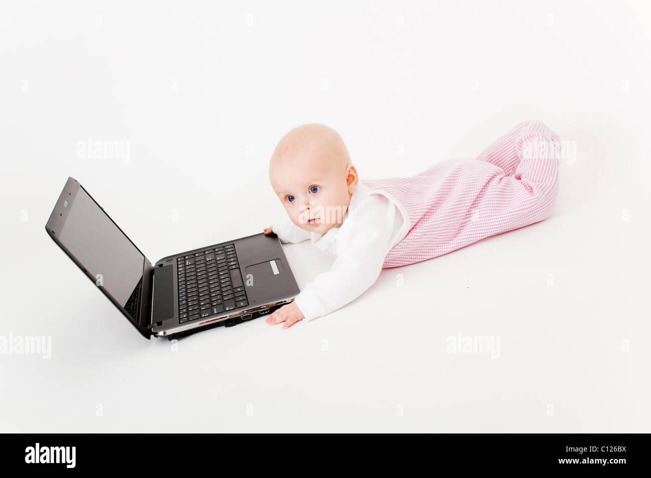 baby with laptop on a white background in studio Stock Photo - Alamy