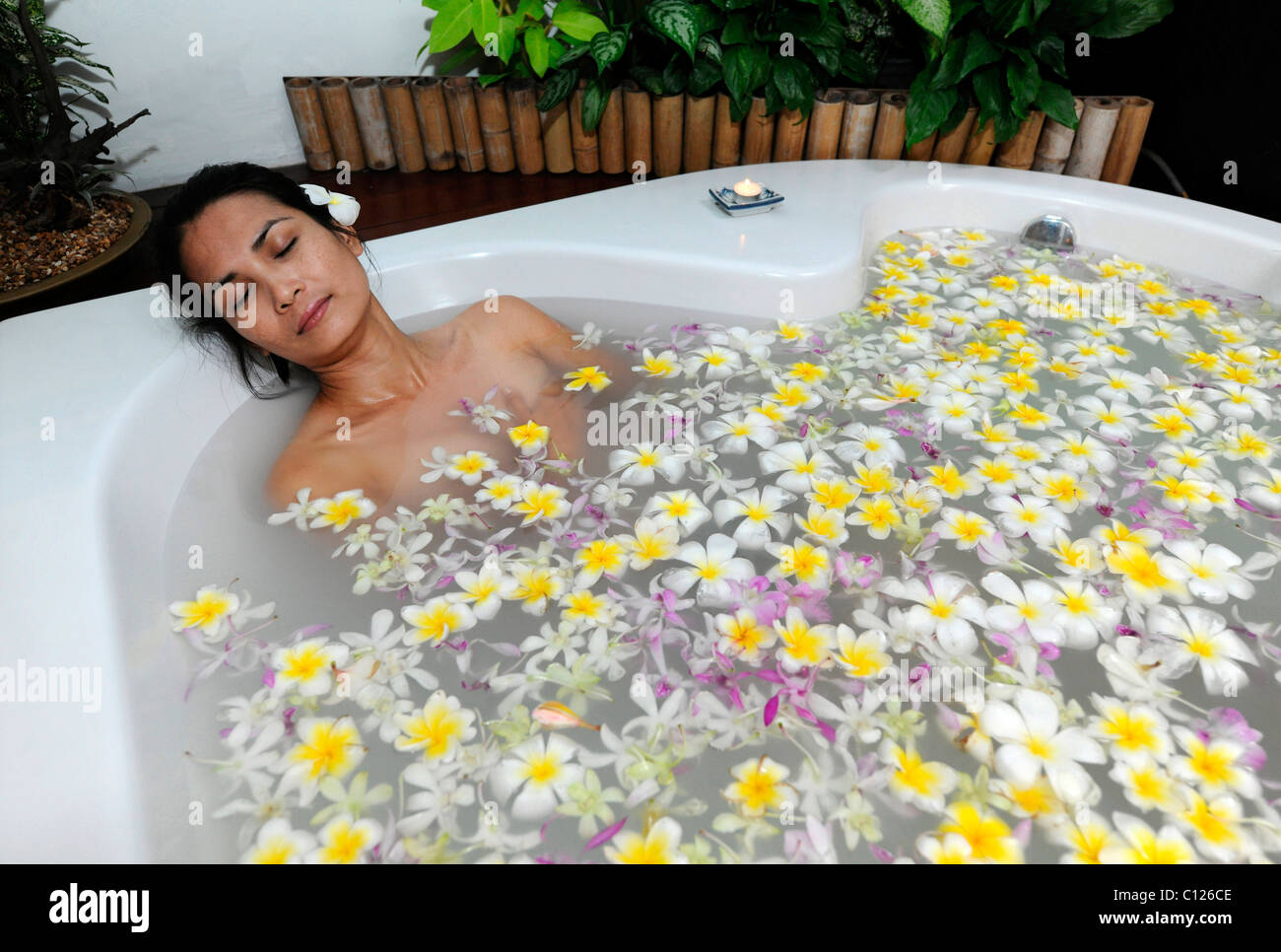 Woman in a sea of flowers in the tub, spa Stock Photo - Alamy
