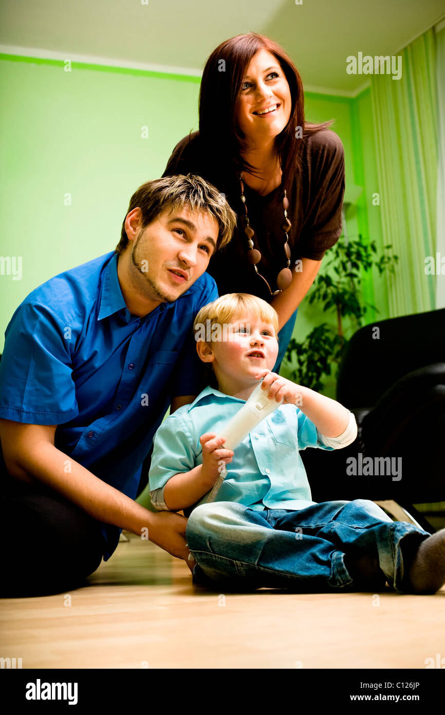 Young family playing with a game console Stock Photo - Alamy