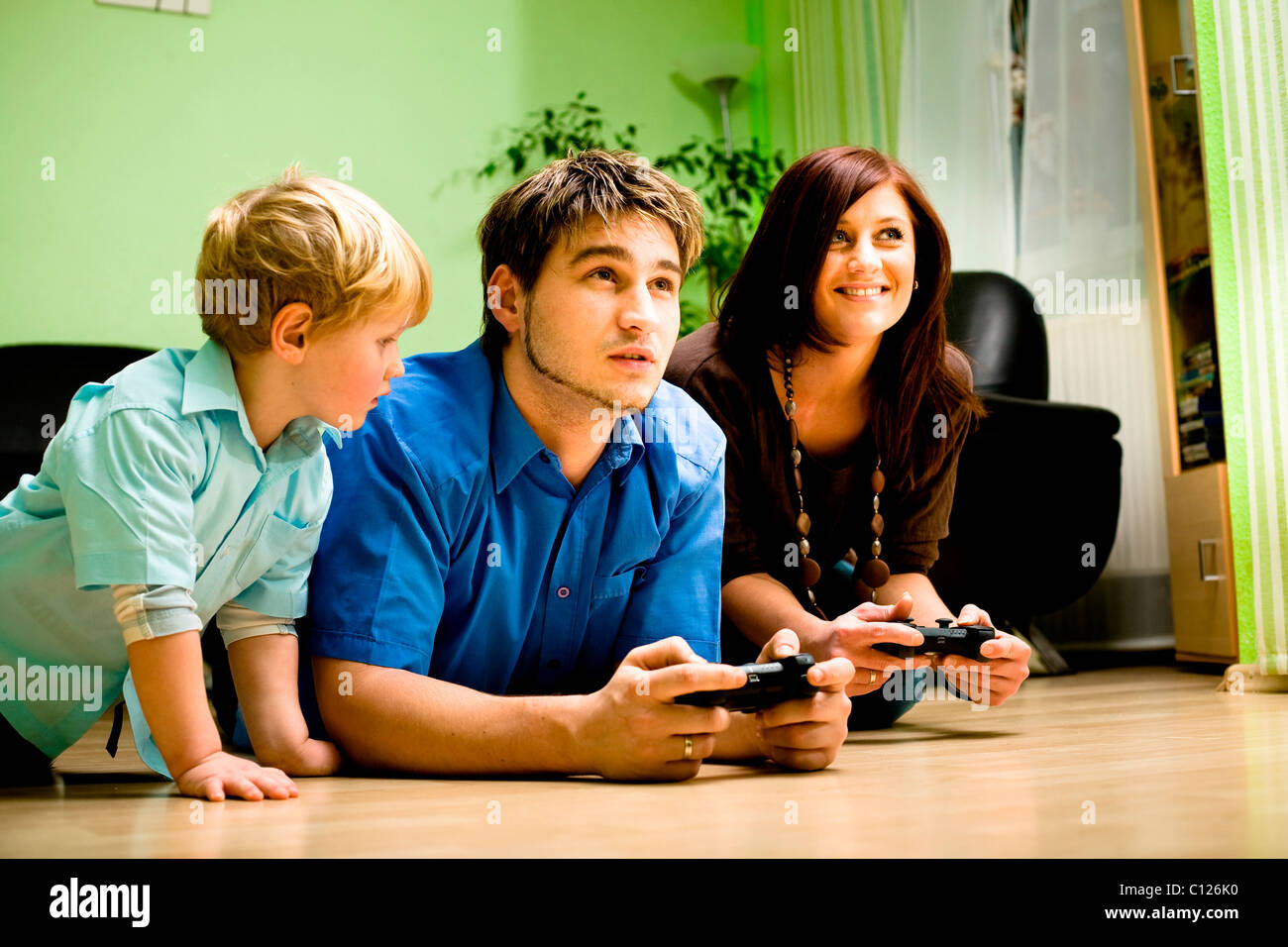 Young family playing with a game console Stock Photo - Alamy