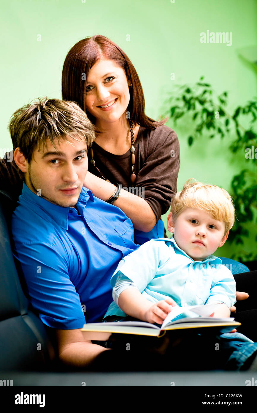 Young family reading Stock Photo - Alamy