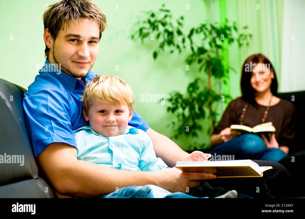 Young family reading Stock Photo - Alamy