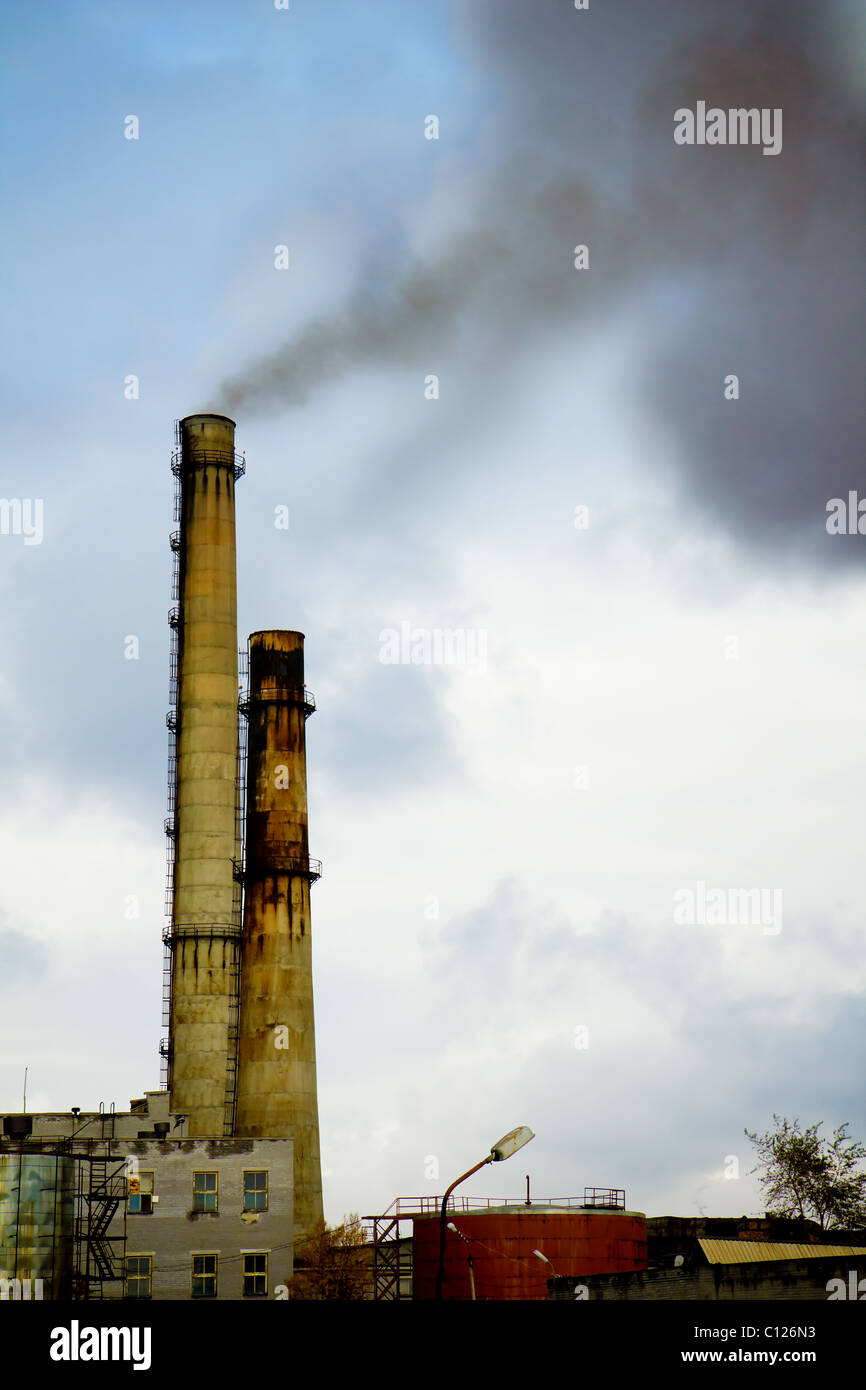 Two old factory smokestack tube against the cloudy sky Stock Photo - Alamy