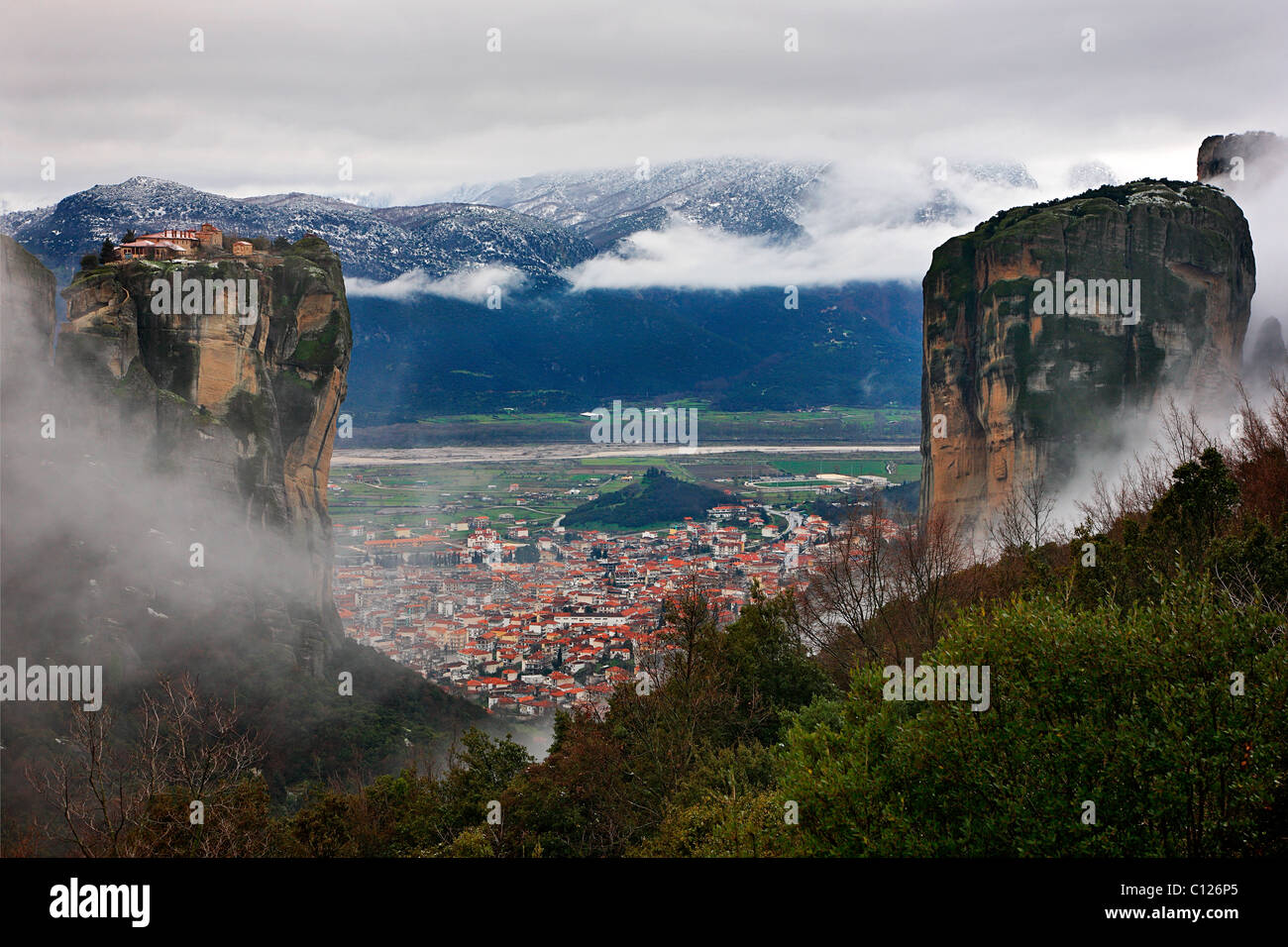 Kalambaka town seen "through" the rocks of Meteora. On top of the left ...