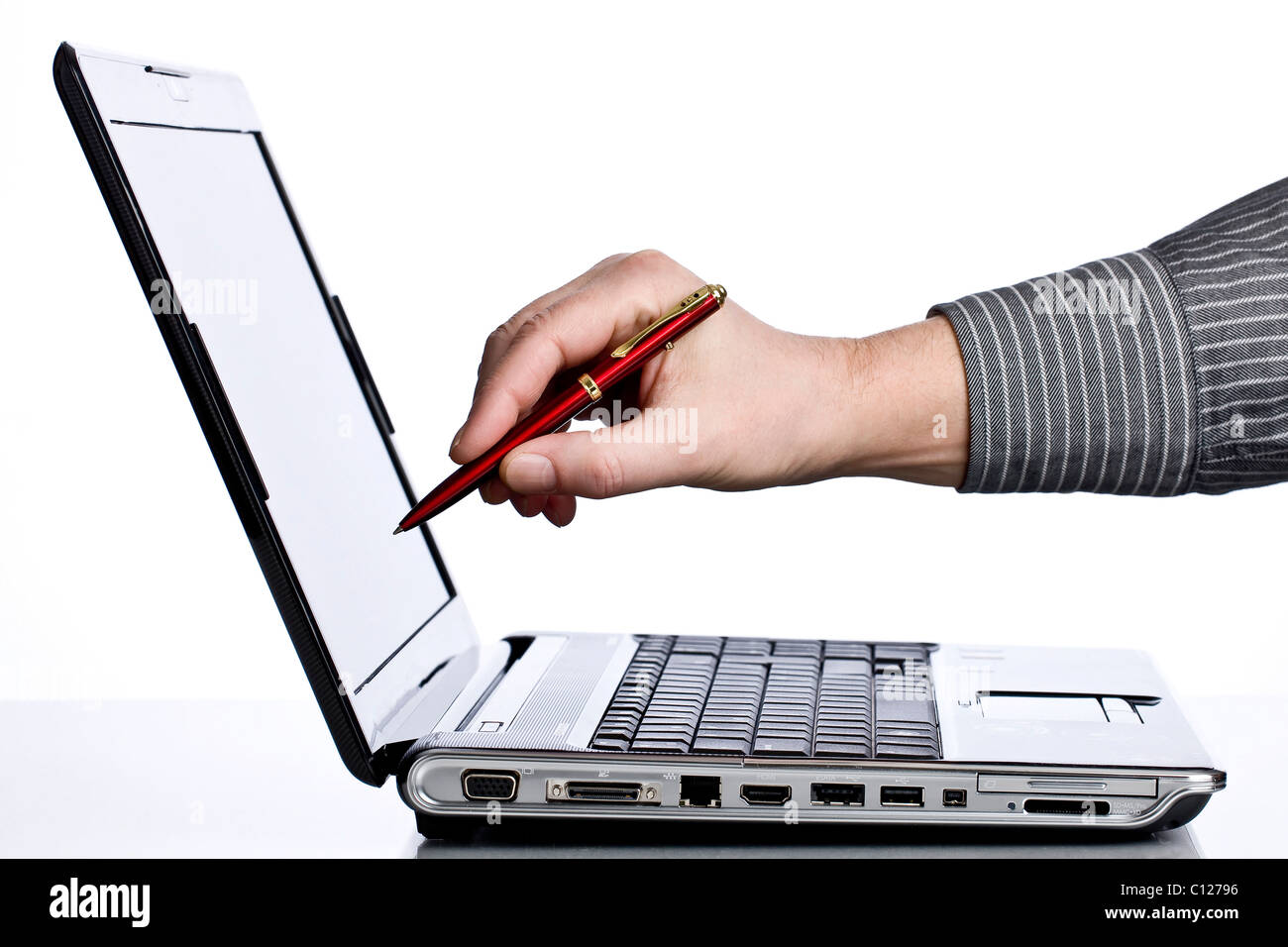 Hand with a ballpoint pointing at a laptop computer screen Stock Photo ...