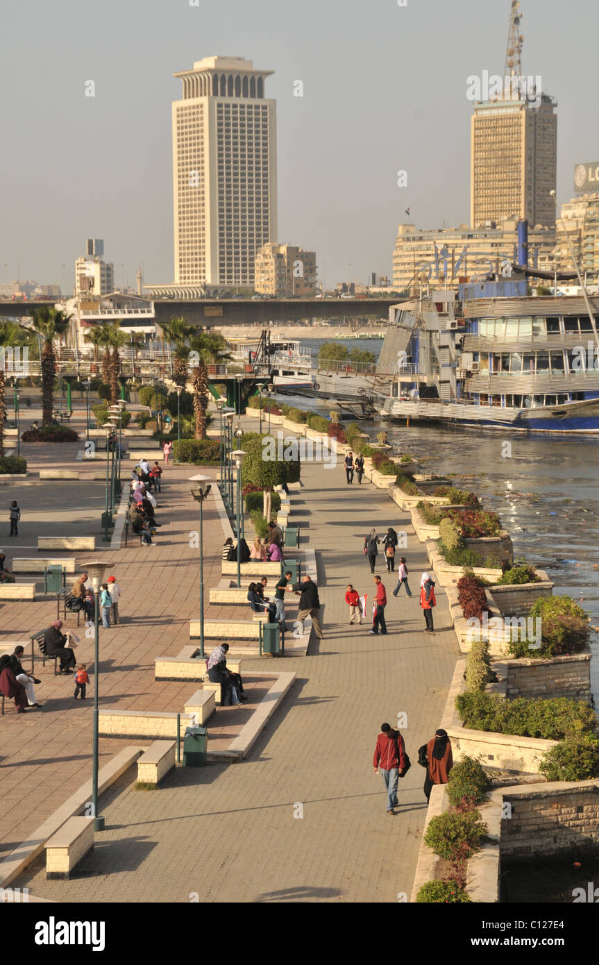 Life continues along a Nileside pedestrian walkway in central Cairo ...