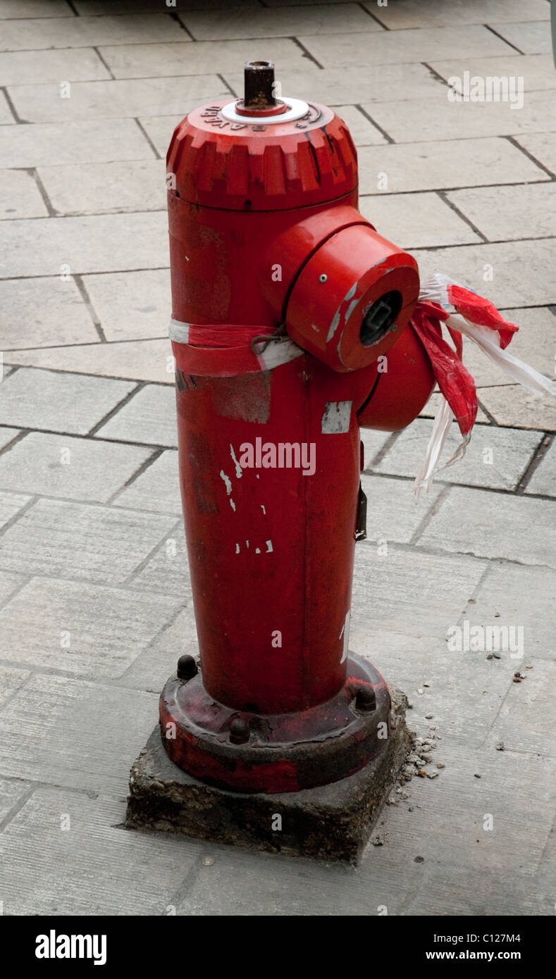 Red water hydrant with tape Stock Photo - Alamy