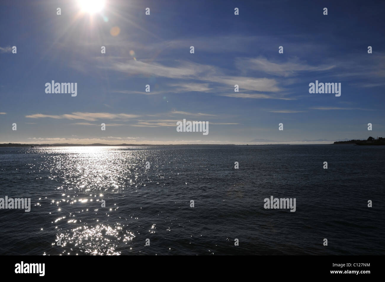 Blue sky white cloud sun-star silhouette view of Chacao Channel west ...