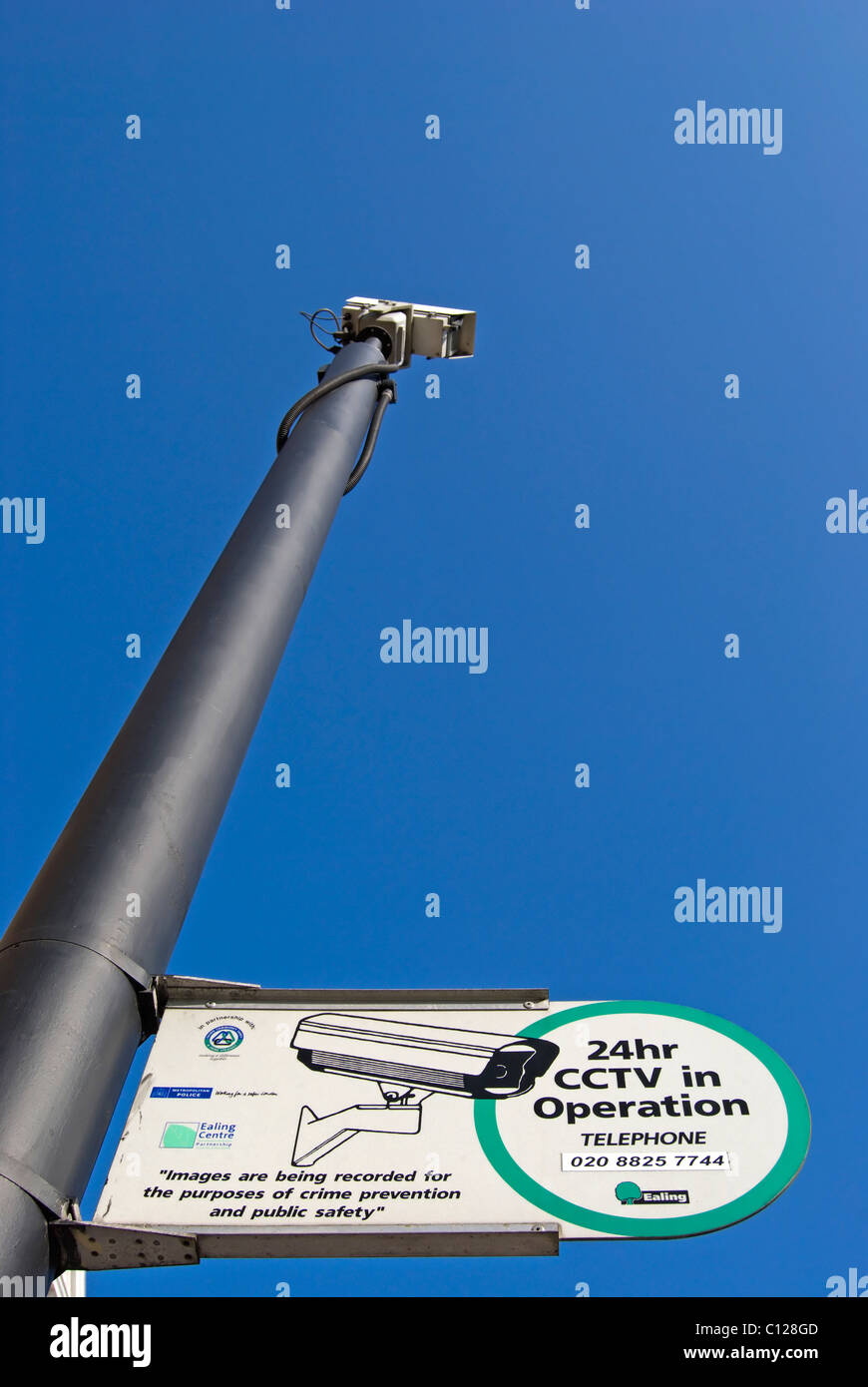cctv camera mounted on pole with sign giving notice of 24 hour cctv ...
