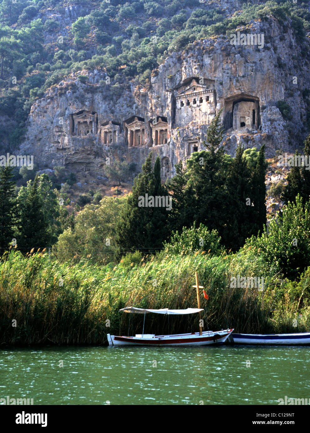 The Lycian rock tombs in the cliffs above the ruins of Kaunos, Kaunus ...